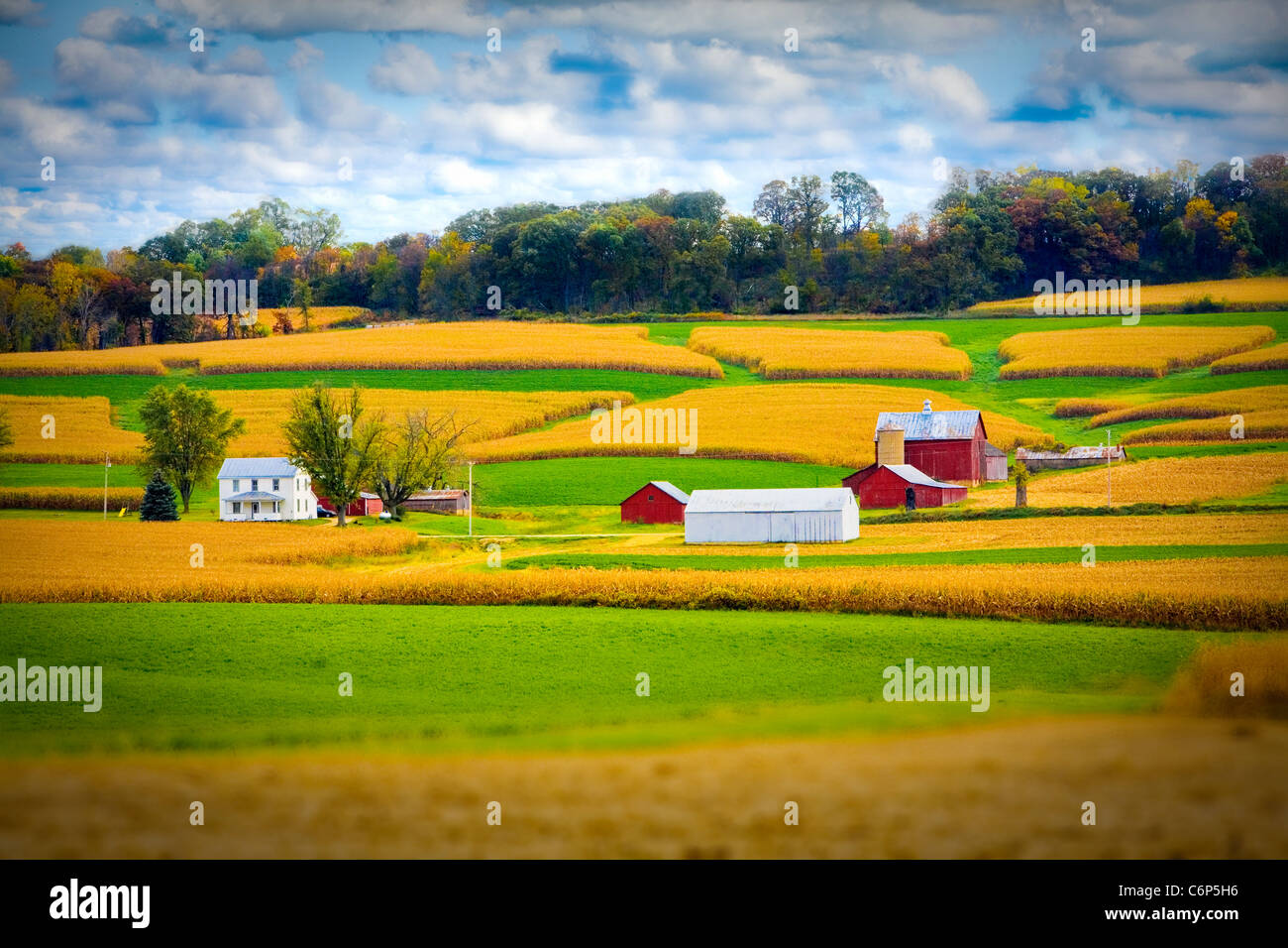 A peaceful rural landscape with a farm and fields Stock Photo - Alamy