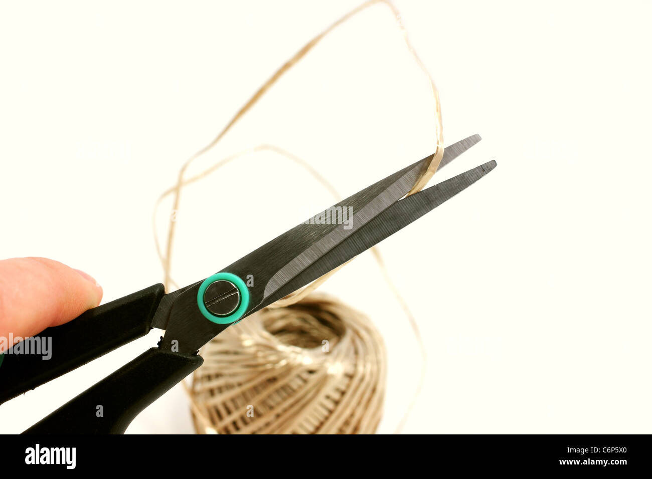 scissors cut golden thread on white Stock Photo - Alamy