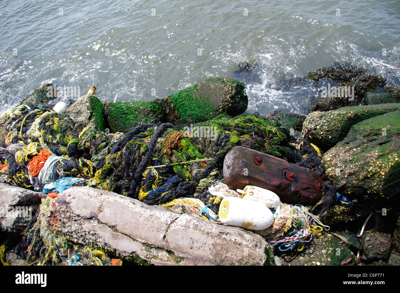 Marine flotsam and jetsam washed up on island seawall Stock Photo - Alamy