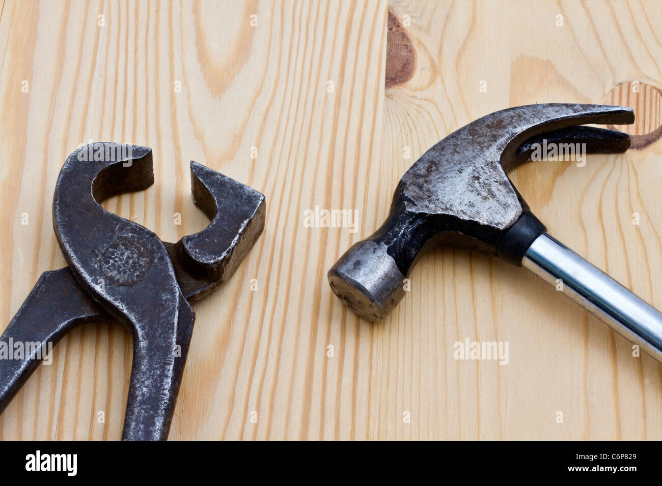 Old wrench and hammer closeup on wood background Stock Photo - Alamy
