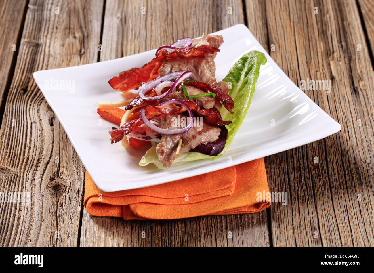 Shish kebab with crispy rashers of bacon and vegetables Stock Photo - Alamy