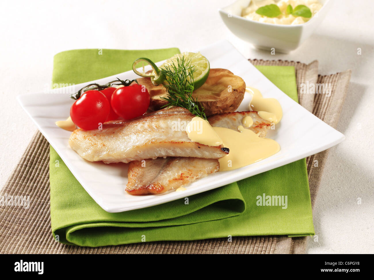 Pan fried fish fillets and Hollandaise sauce Stock Photo - Alamy