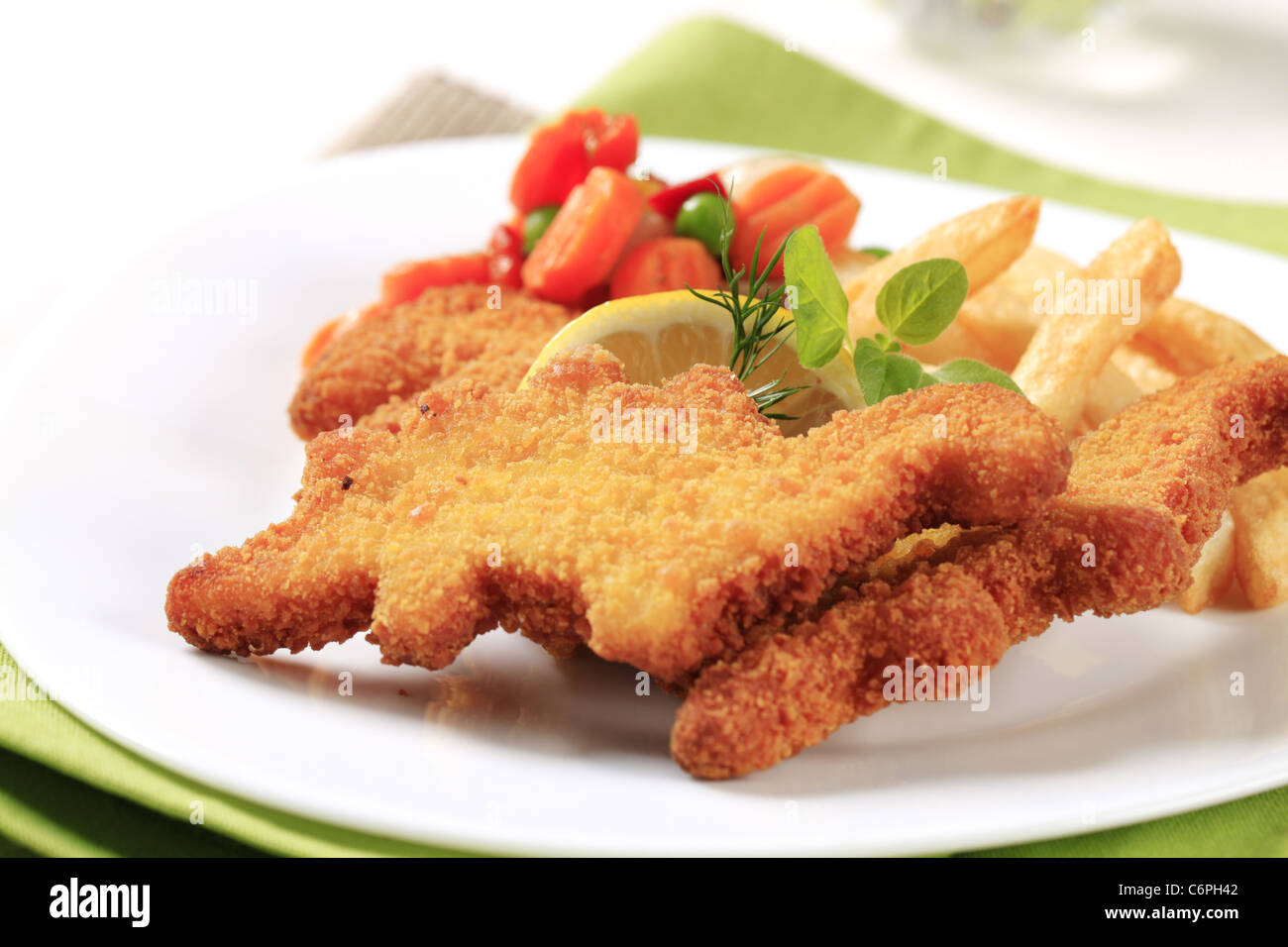 Fried fish served with French fries and mixed vegetables Stock Photo ...
