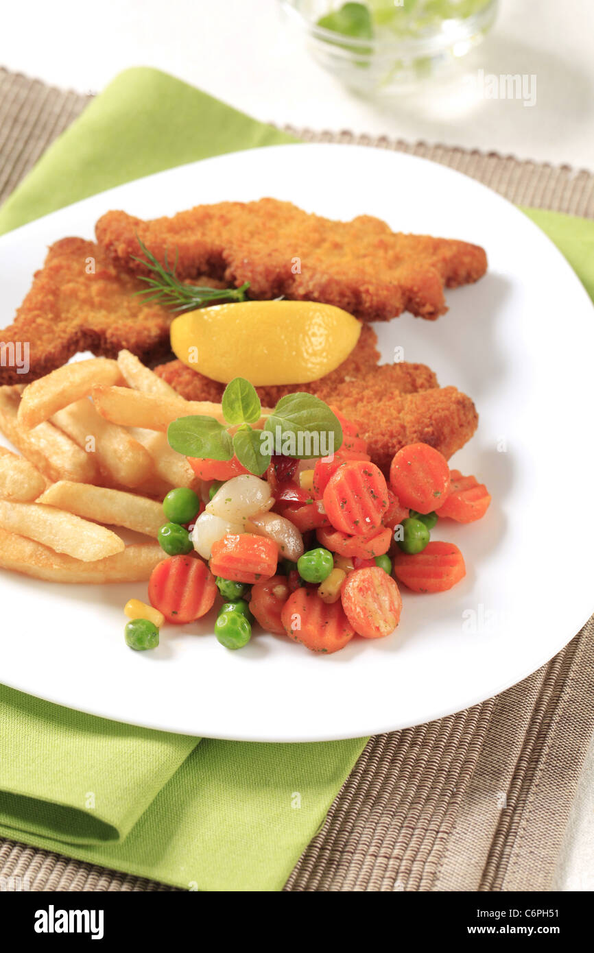 Fried fish served with French fries and mixed vegetables Stock Photo ...
