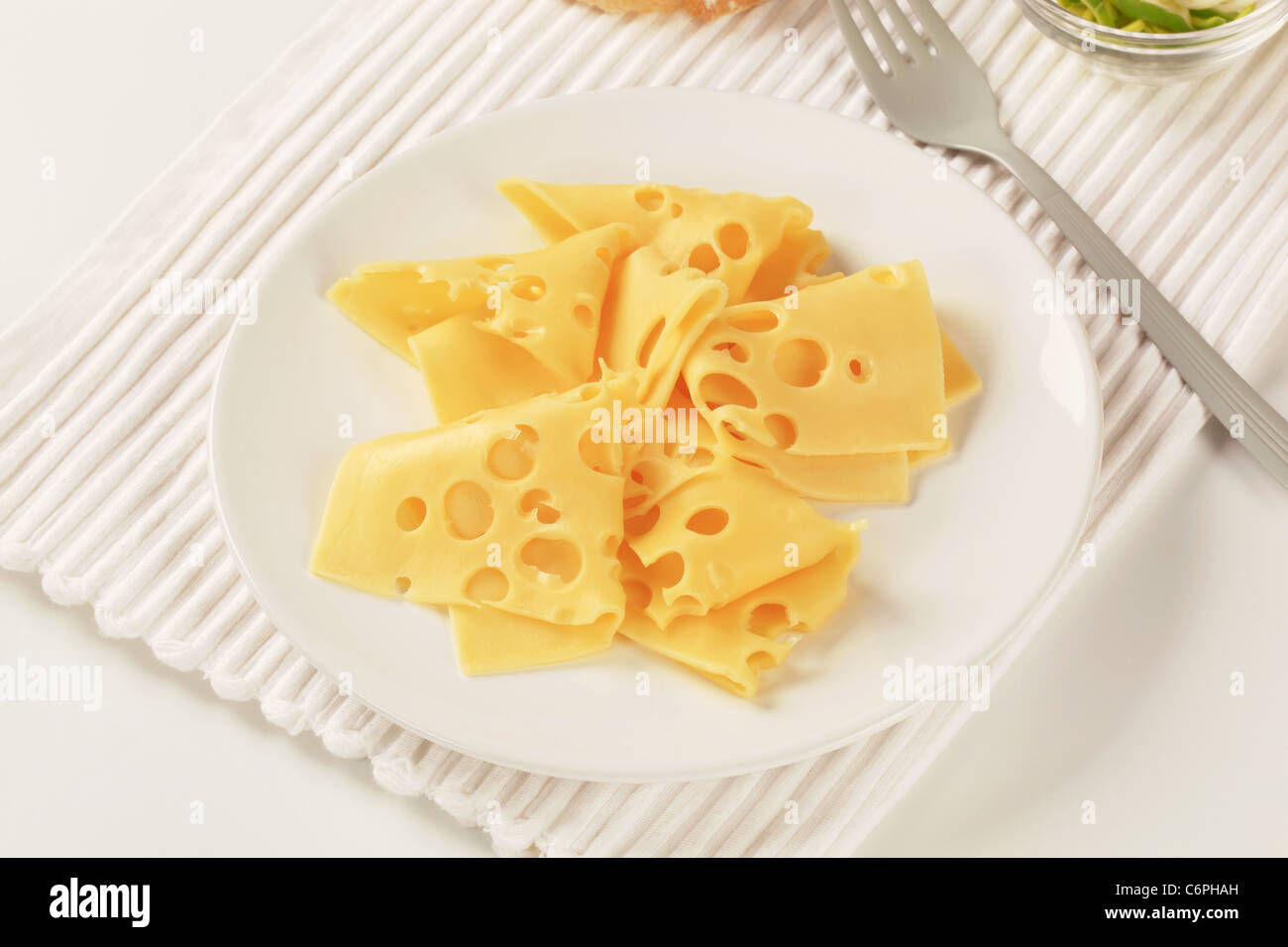 Thin slices of Swiss cheese on a plate Stock Photo - Alamy