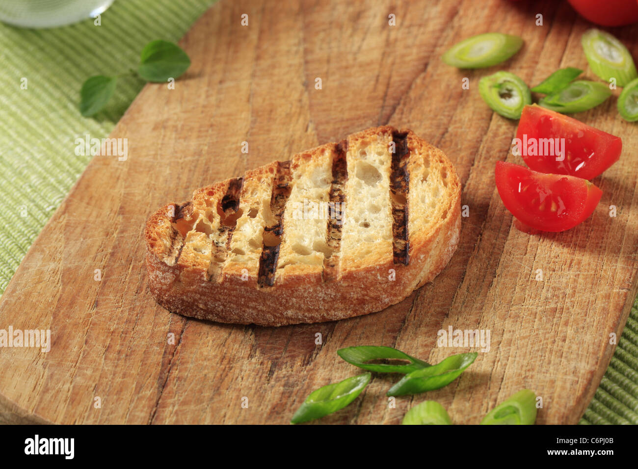 Slice of grill toasted bread on a cutting board Stock Photo - Alamy