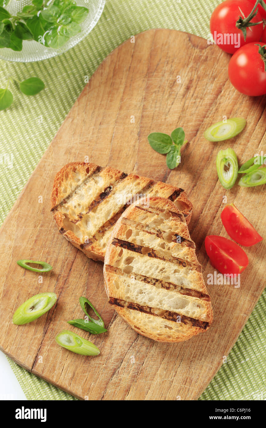Slices of grill toasted bread on a cutting board Stock Photo - Alamy