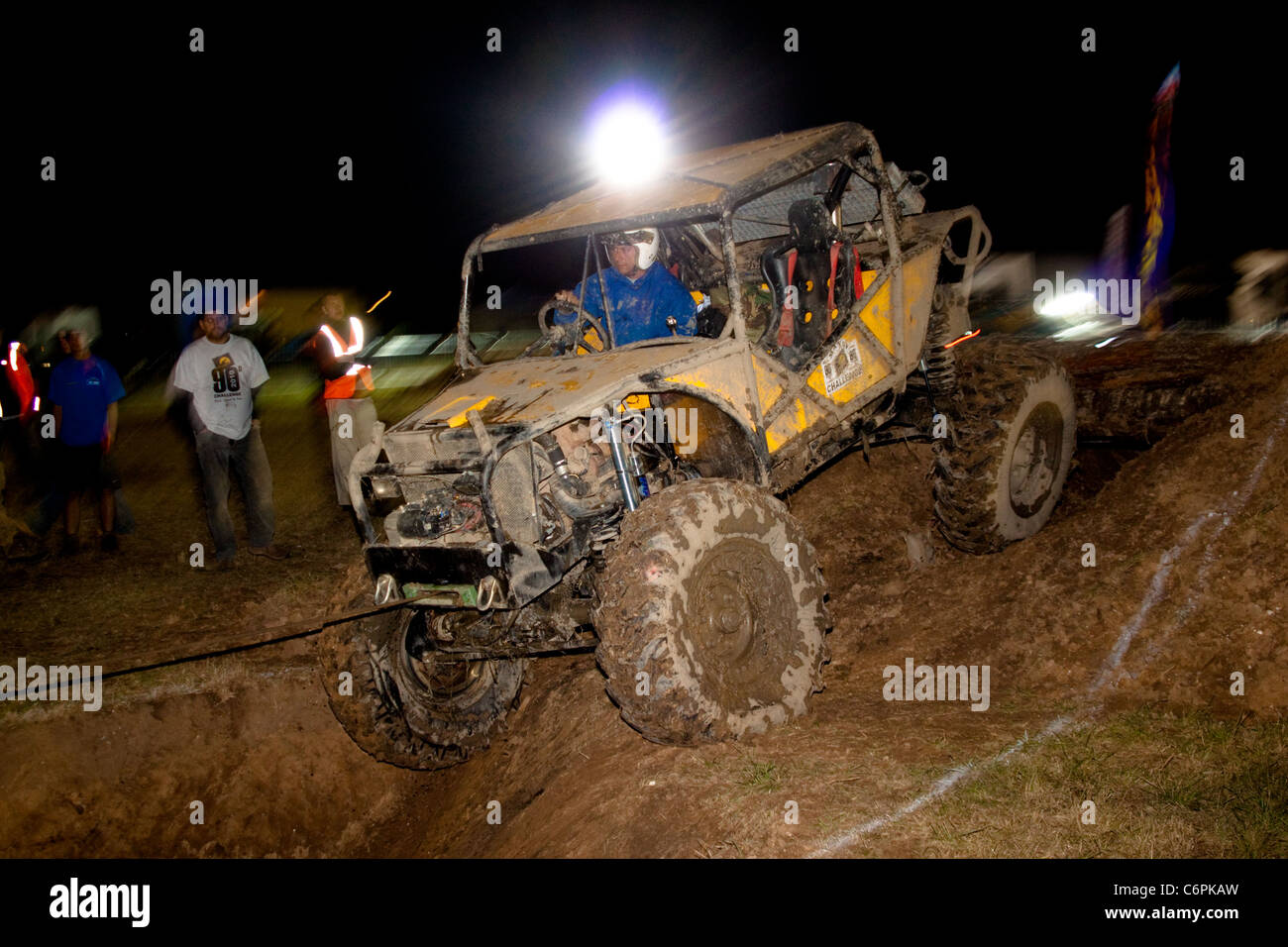 Modified Land Rover challenge vehicle competing at night in Manby Stock ...