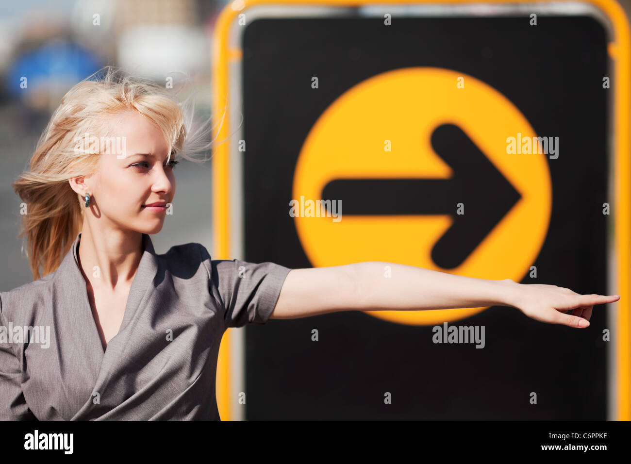 Young woman pointing a direction Stock Photo - Alamy