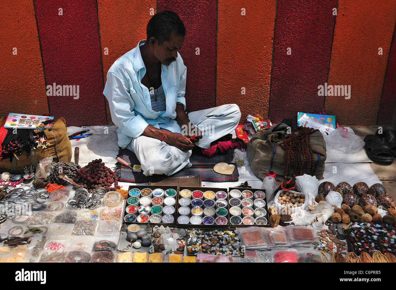 The man selling colorful stones on the street Stock Photo - Alamy