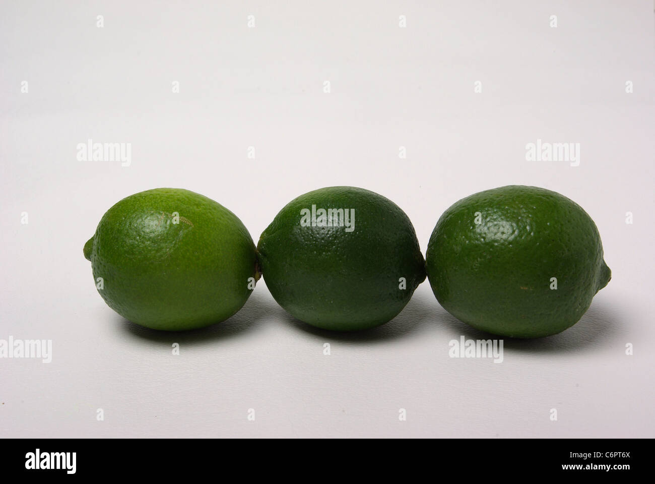 Three limes are on a white background Stock Photo - Alamy