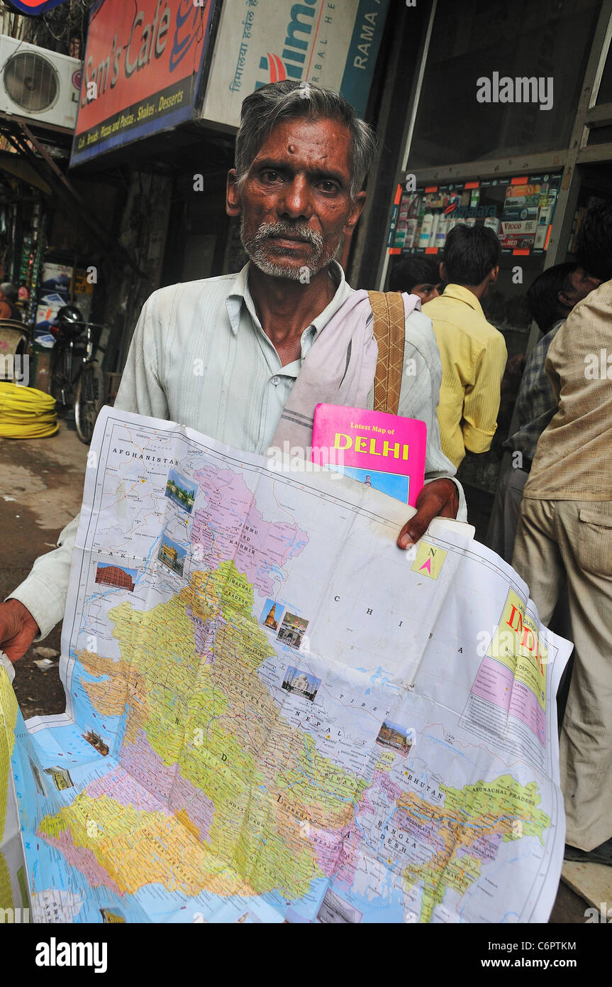 Man selling map on the shopping street Stock Photo - Alamy