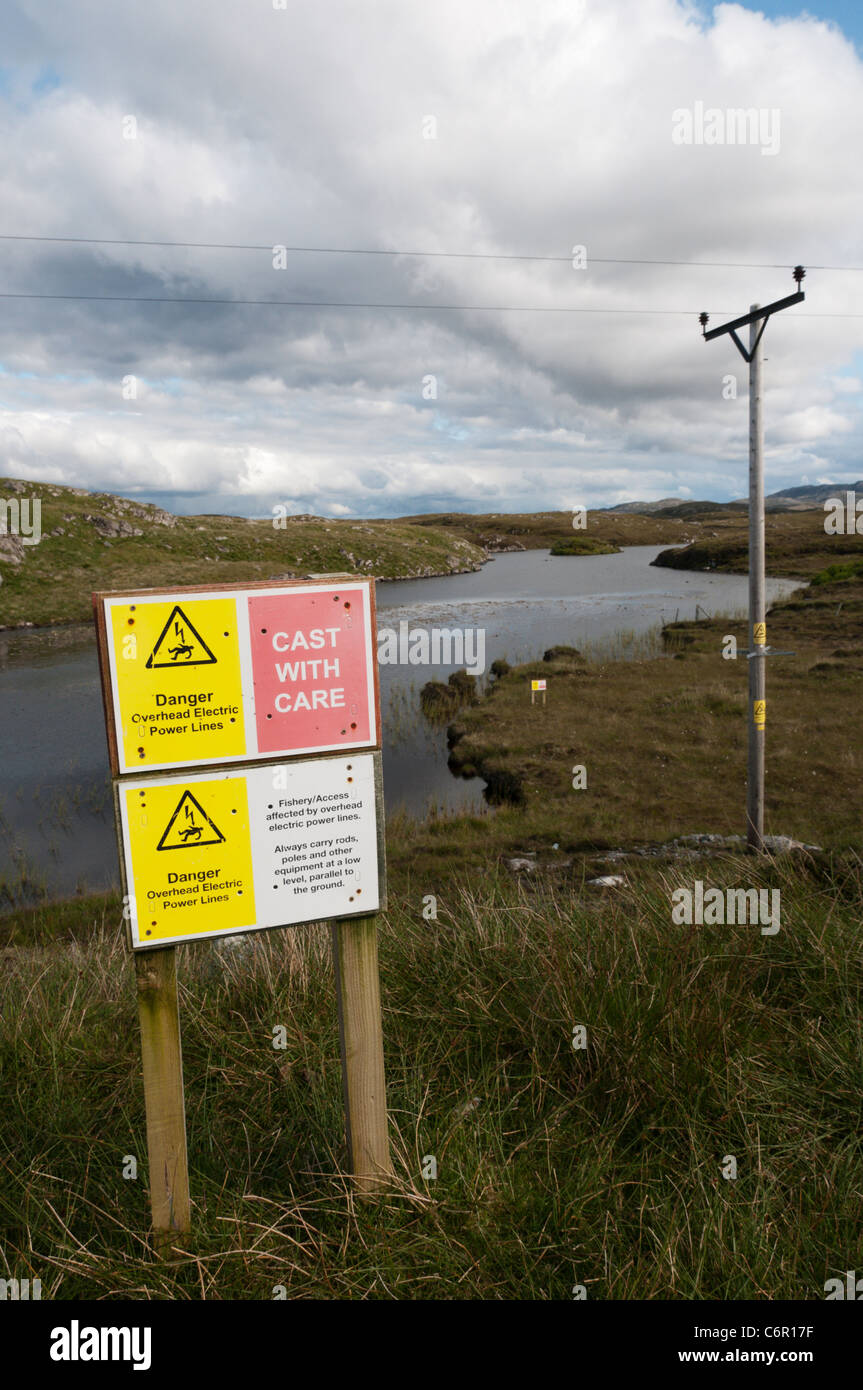 A Health and Safety sign warns of the dangers of fishing rods touching ...