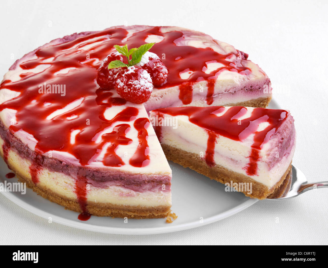 Home baked raspberry cheesecake drizzled raspberry coulis hi-res stock ...