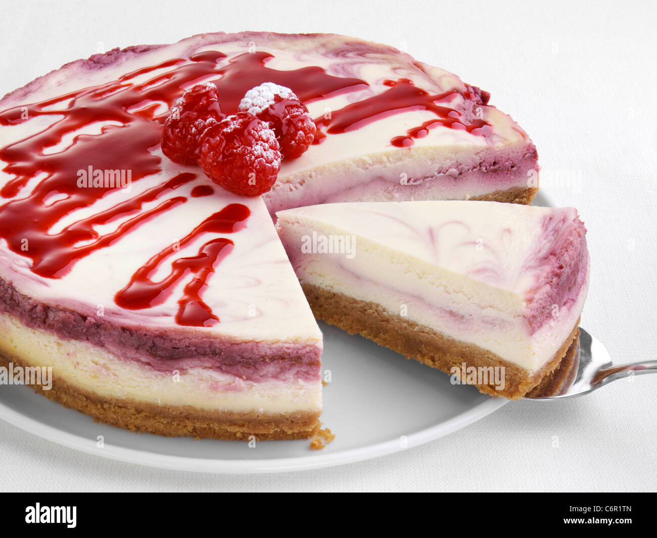Home baked raspberry cheesecake drizzled raspberry coulis hi-res stock ...