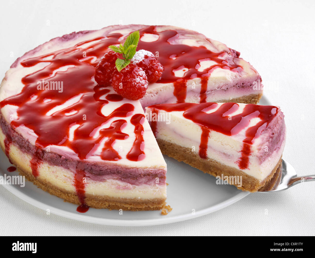 Home baked raspberry cheesecake drizzled raspberry coulis hi-res stock ...