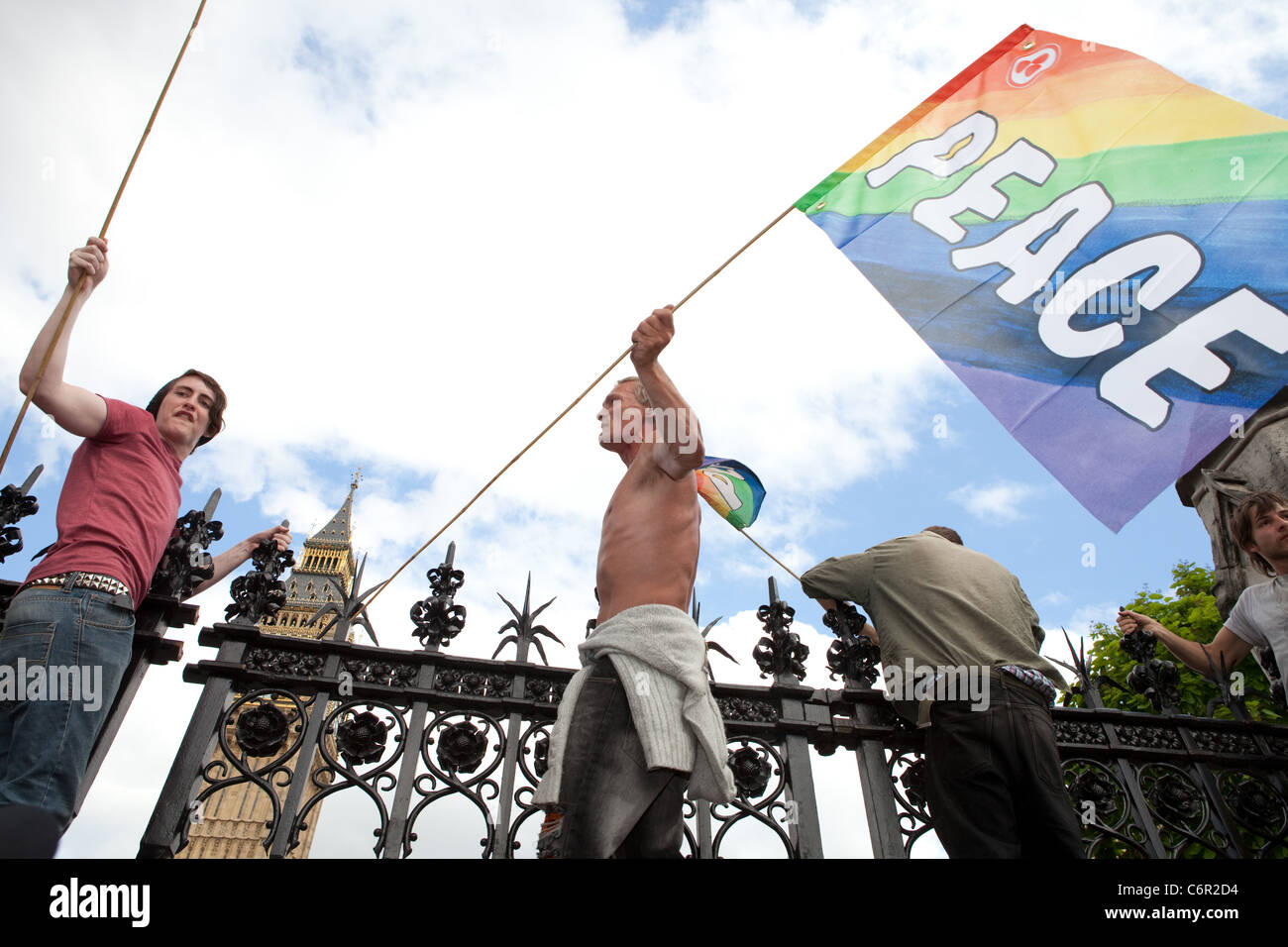 Democracy Village campers hang peace flags on the gates of the Houses ...