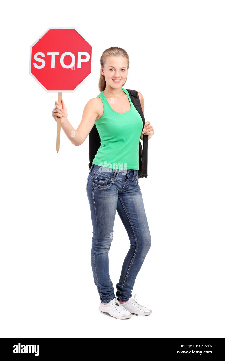 Full length portrait of a young woman holding a traffic sign stop Stock ...