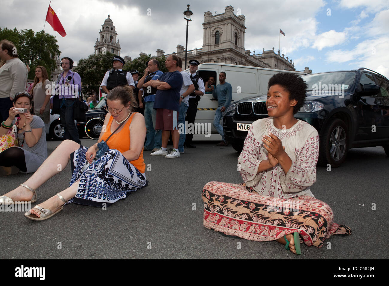 Democracy Village campers hold a peaceful sit-down protest outside the ...