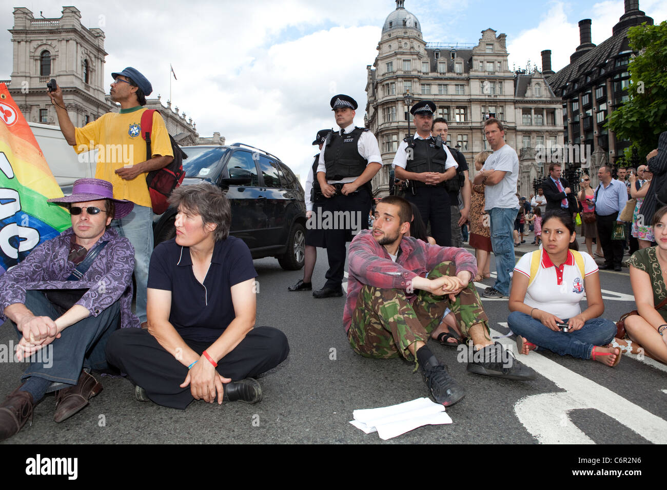 Democracy Village campers hold a peaceful sit-down protest outside the ...