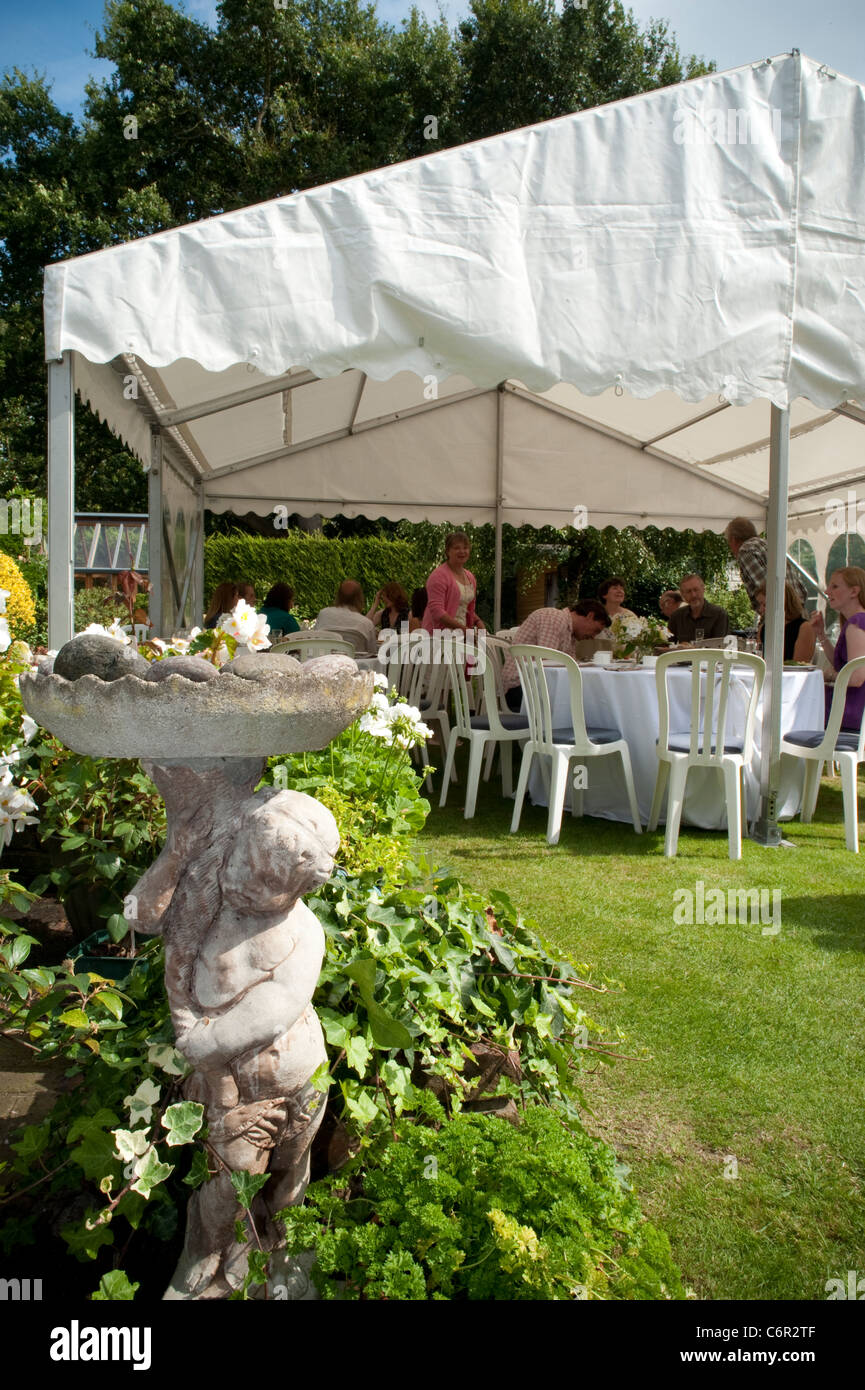 White small canope in a garden on a sunny day in September for a party ...