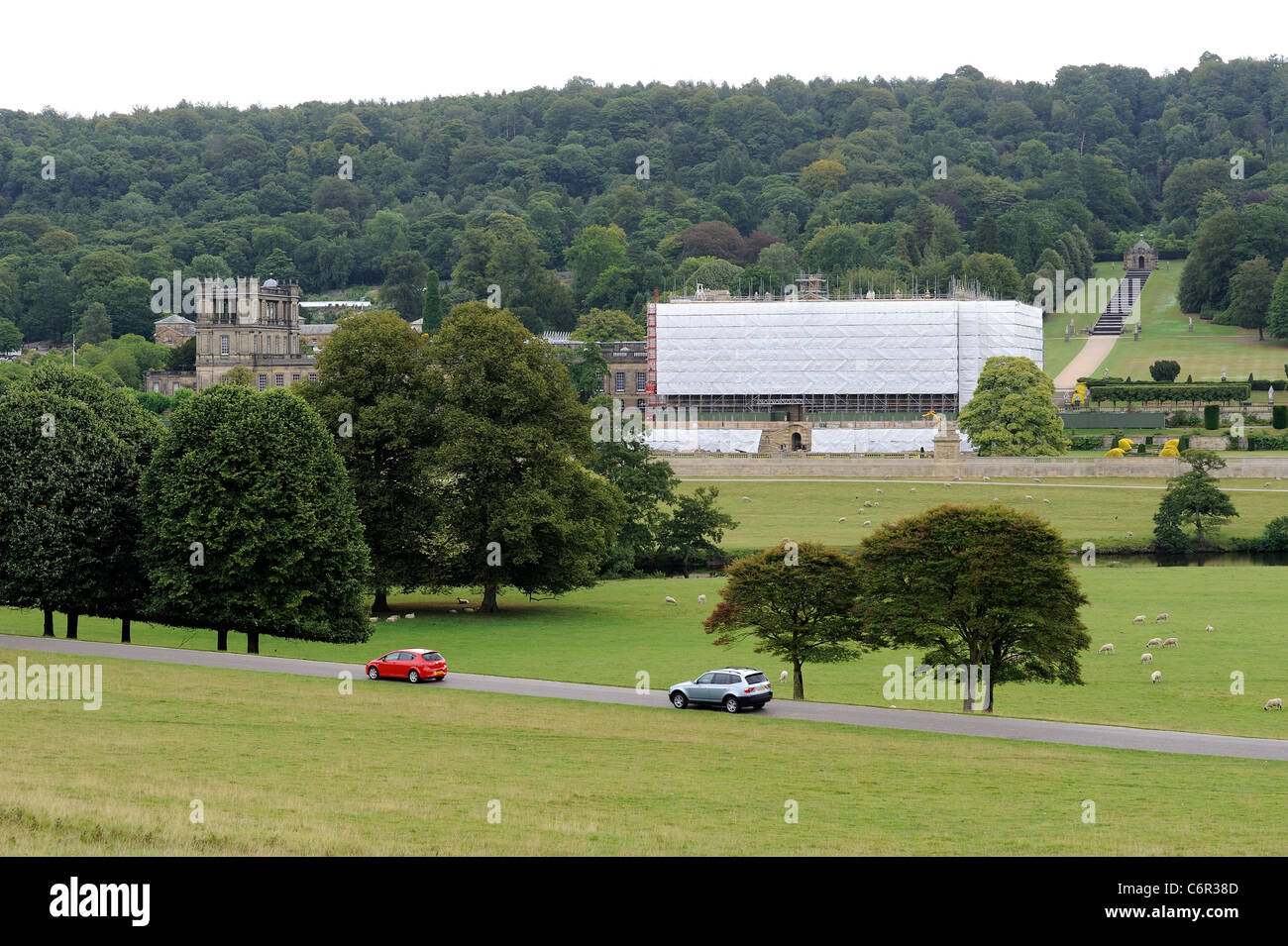 cars passing through chatsworth park estate with chatsworth house in ...