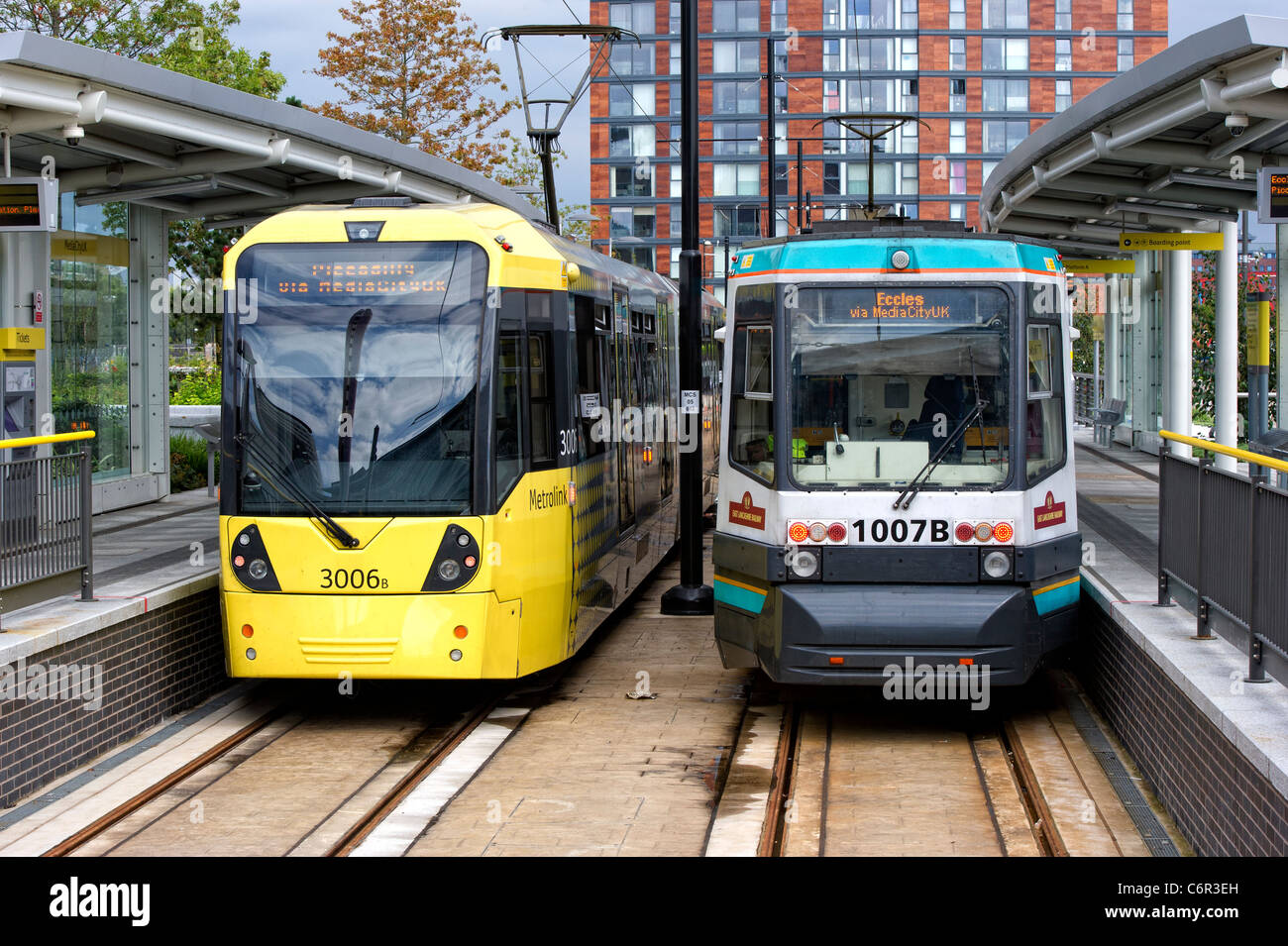 Pair of trams on the Manchester Metrolink system waiting side by side ...