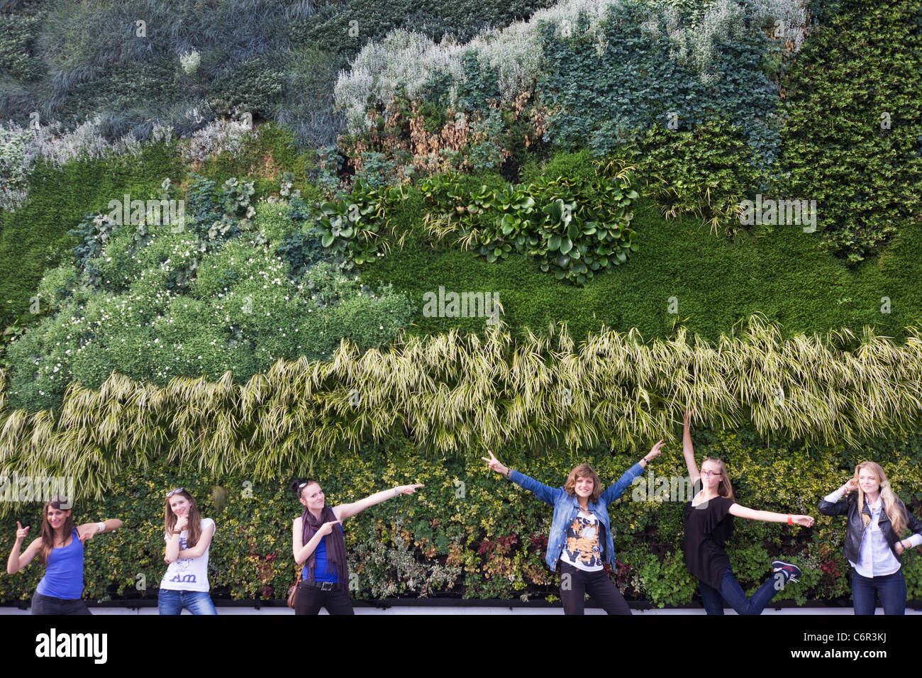 Women stand in front of the GE Ecomagination living wall art project at ...