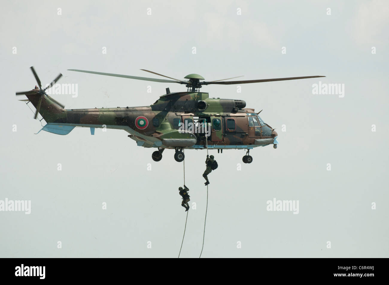 Two soldiers hanging from a helicopter. Horizontal image Stock Photo ...