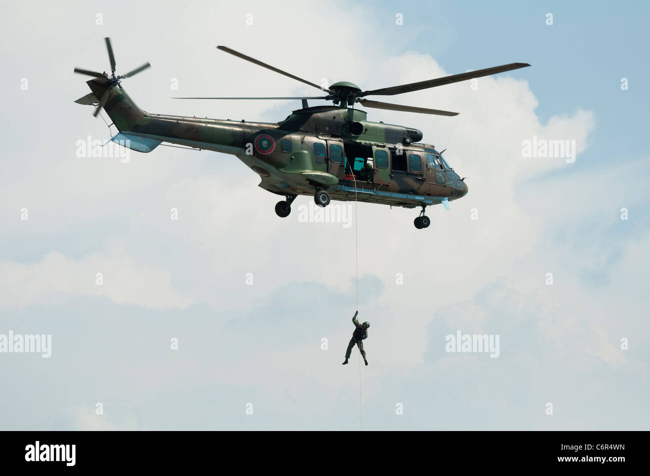 Soldier hanging from a helicopter. Horizontal image Stock Photo - Alamy