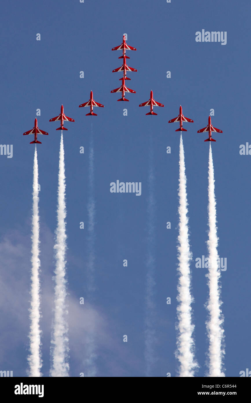 RAF [Red Arrows] squadron of Hawk T1 jets flying in Swan formation with ...