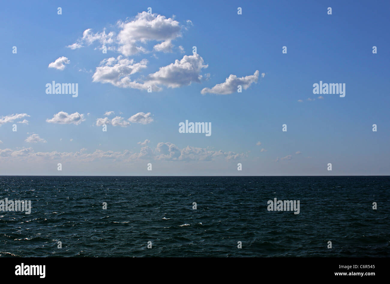 sea under blue sky with clouds Stock Photo - Alamy