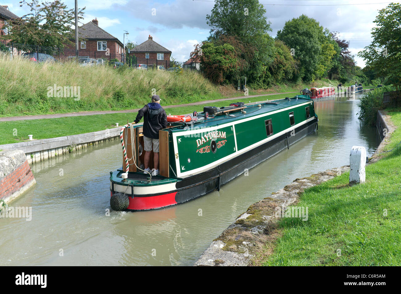 Narrow boat leaving locks at Devizes Stock Photo - Alamy