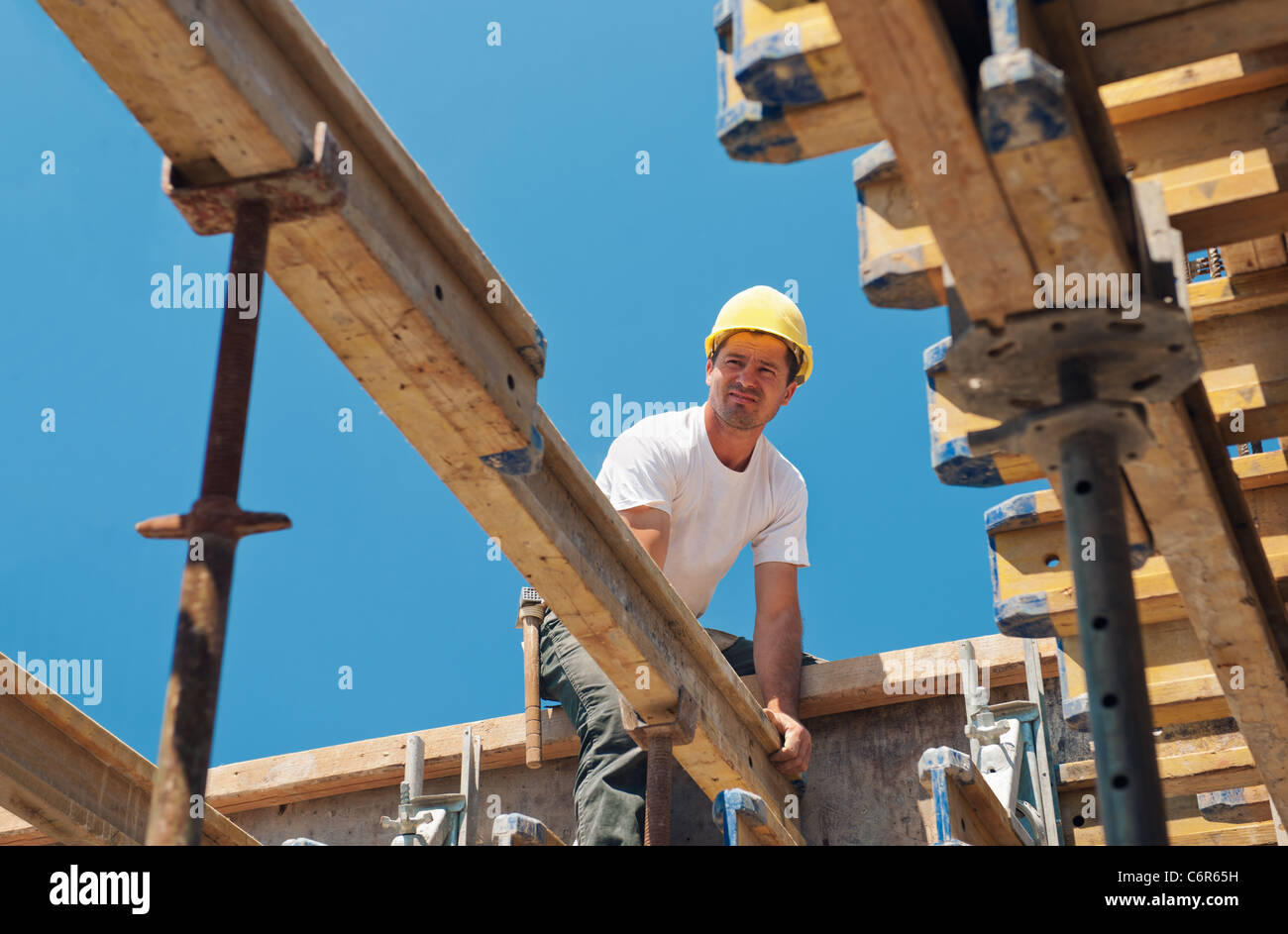 Construction worker placing formwork beams Stock Photo - Alamy