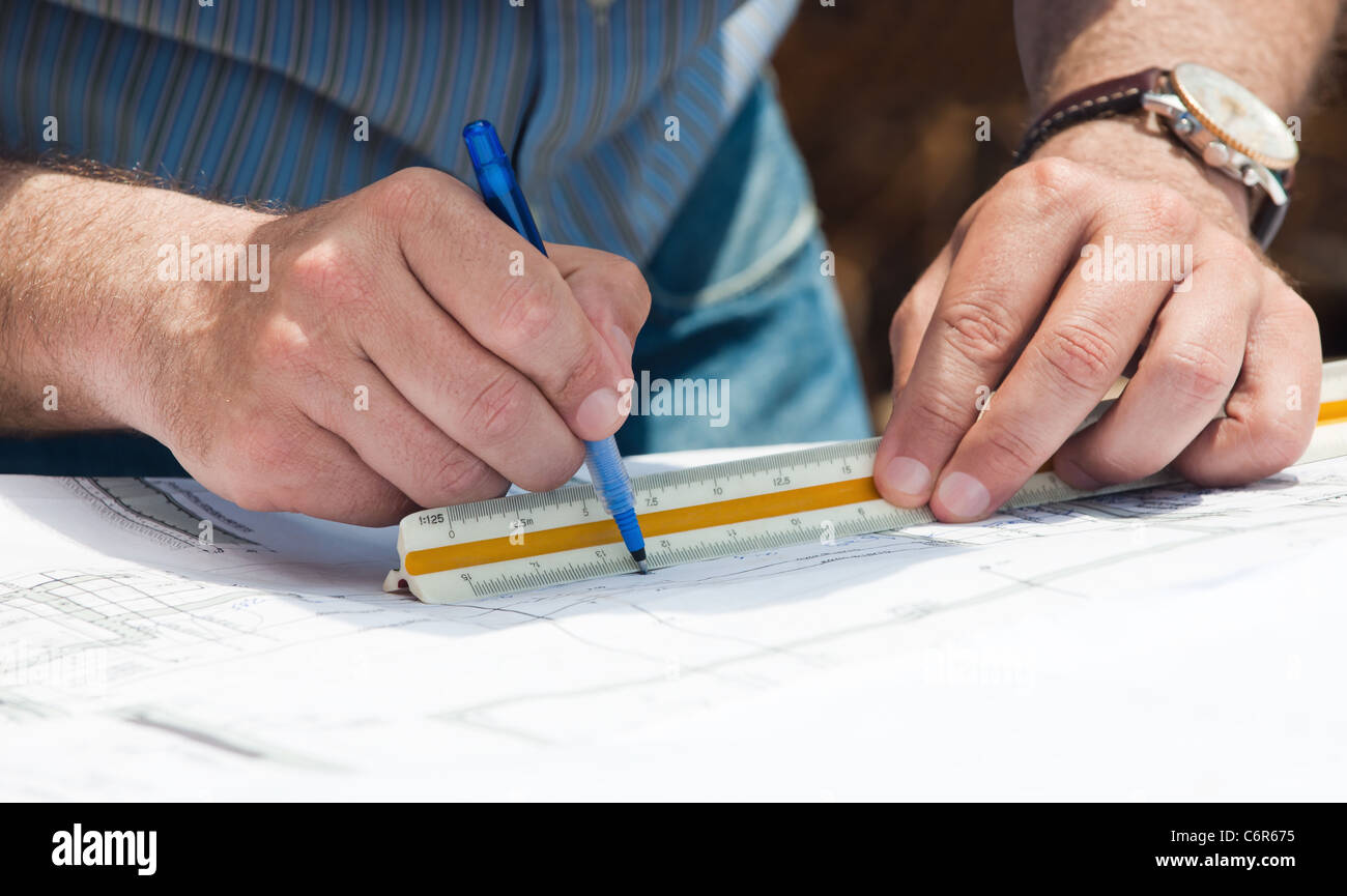 Working on construction plans Stock Photo - Alamy