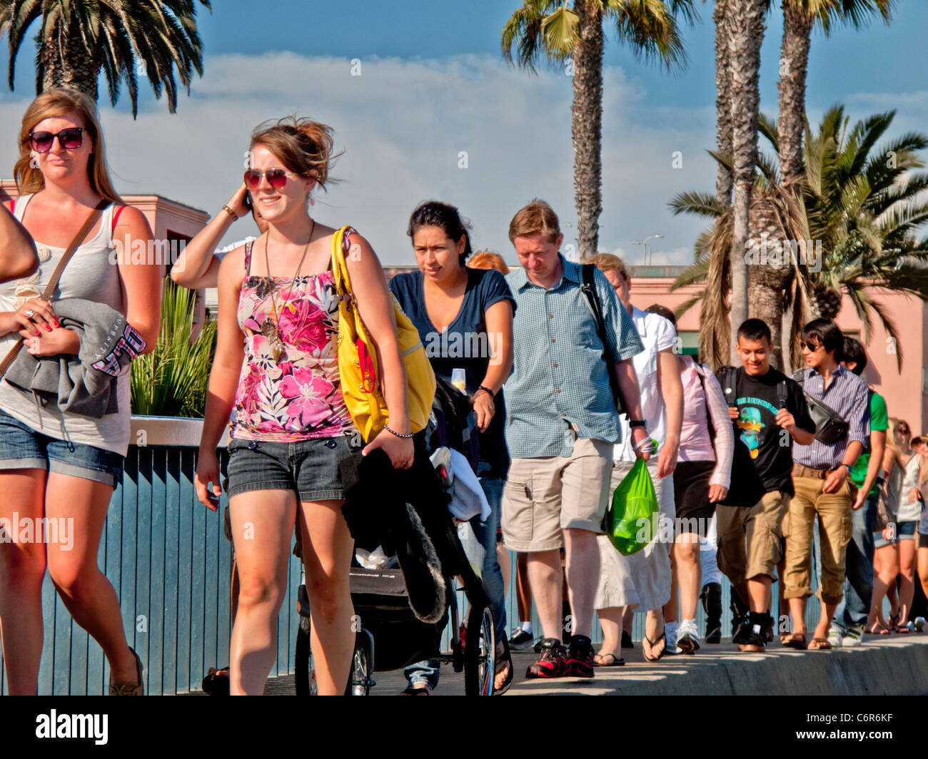 A weekend summer crowd of different ages and ethnicities arrives at the ...