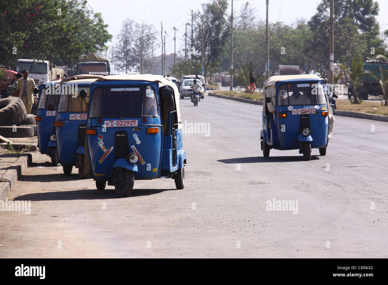 Street crowded with traffic and blue bajaj taxis Stock Photo - Alamy