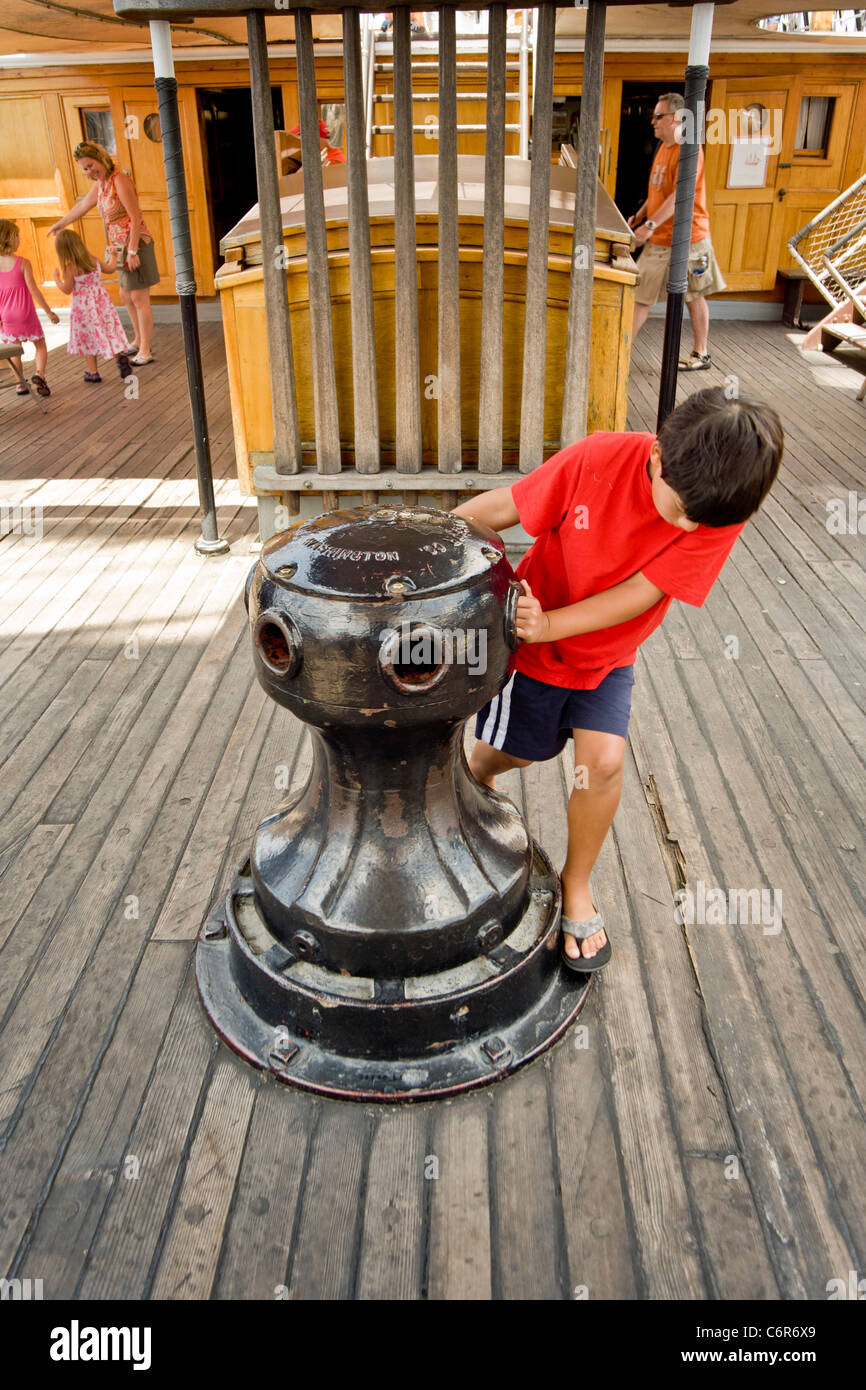 A boy plays around the capstan of the sailing ship Star of India at the ...