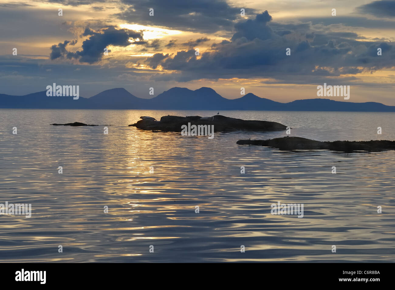 Sun setting over the Island of Jura on the west coast of Scotland, UK ...