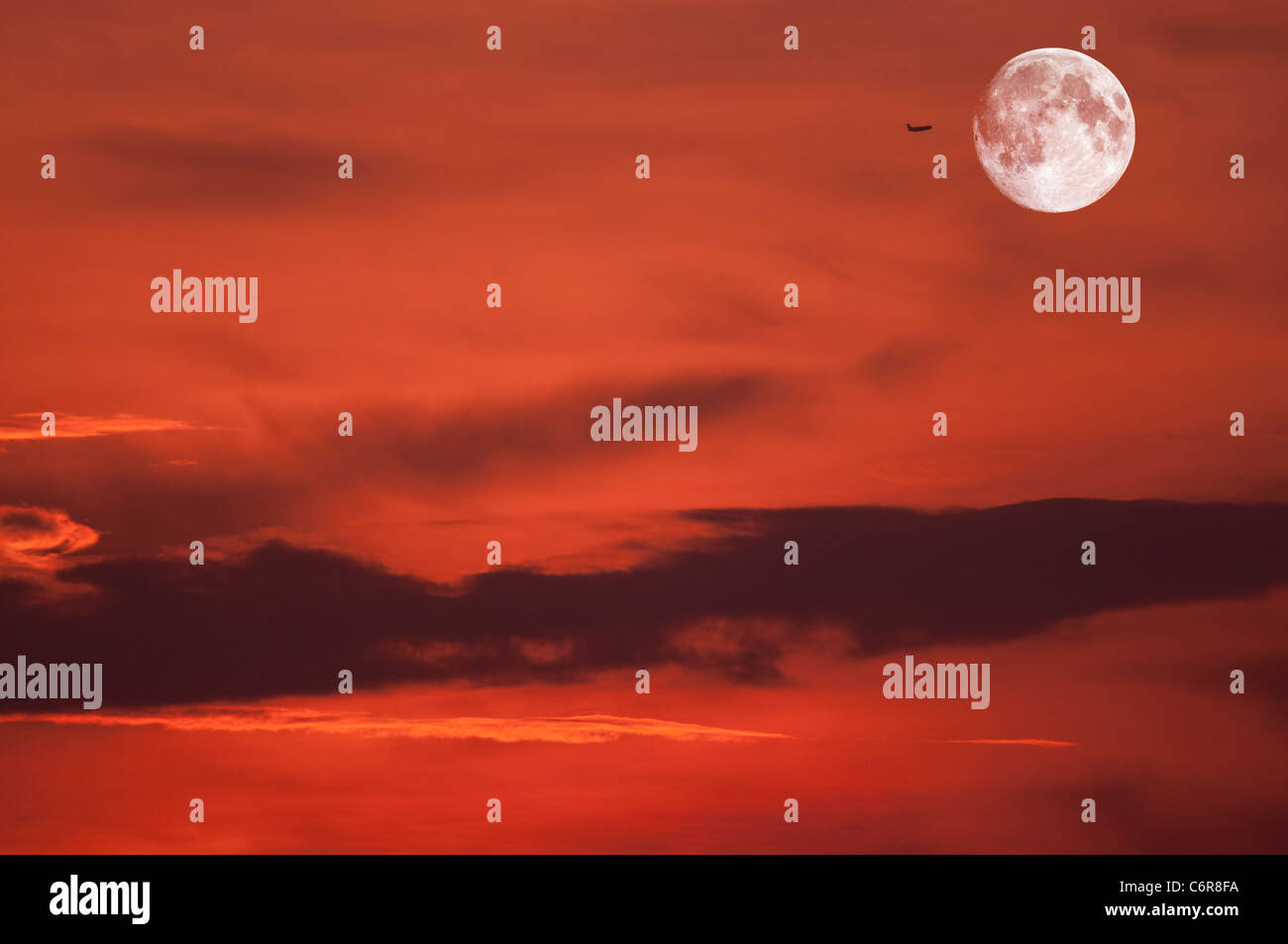 An air plane soaring high in the sky during full moon Stock Photo - Alamy