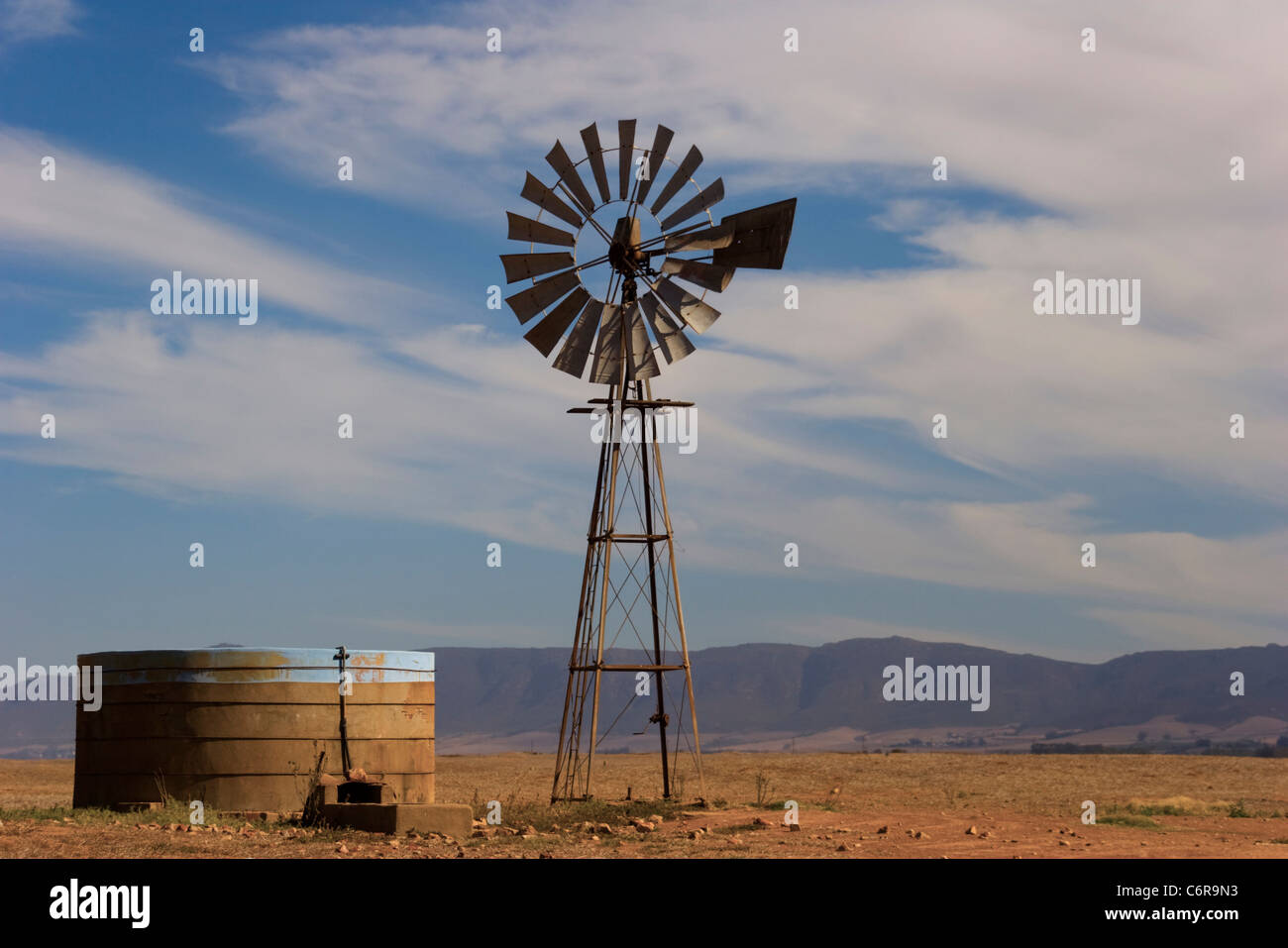 Windmill and dam on a farm Stock Photo - Alamy