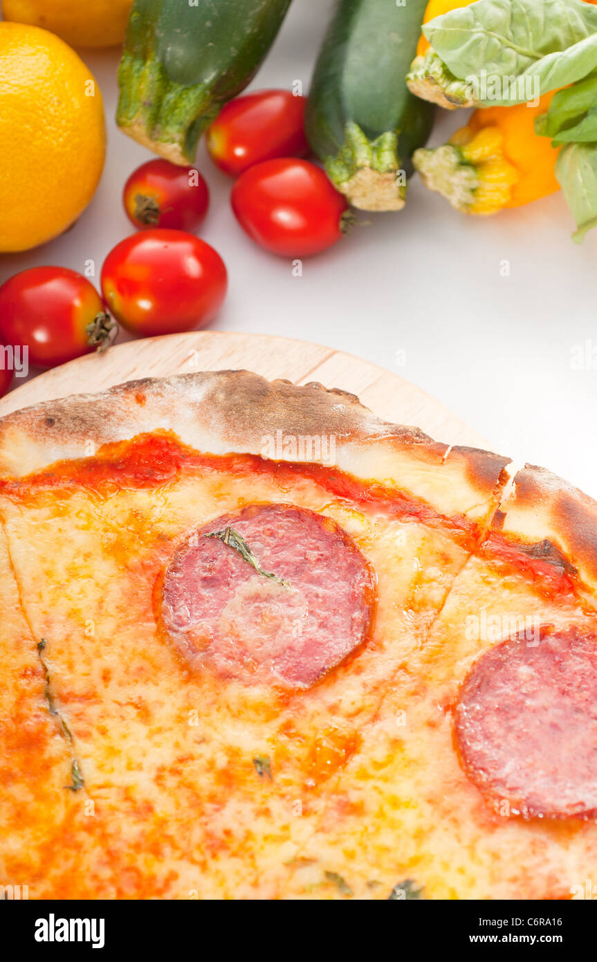 Italian original thin crust pepperoni pizza with fresh vegetables on ...