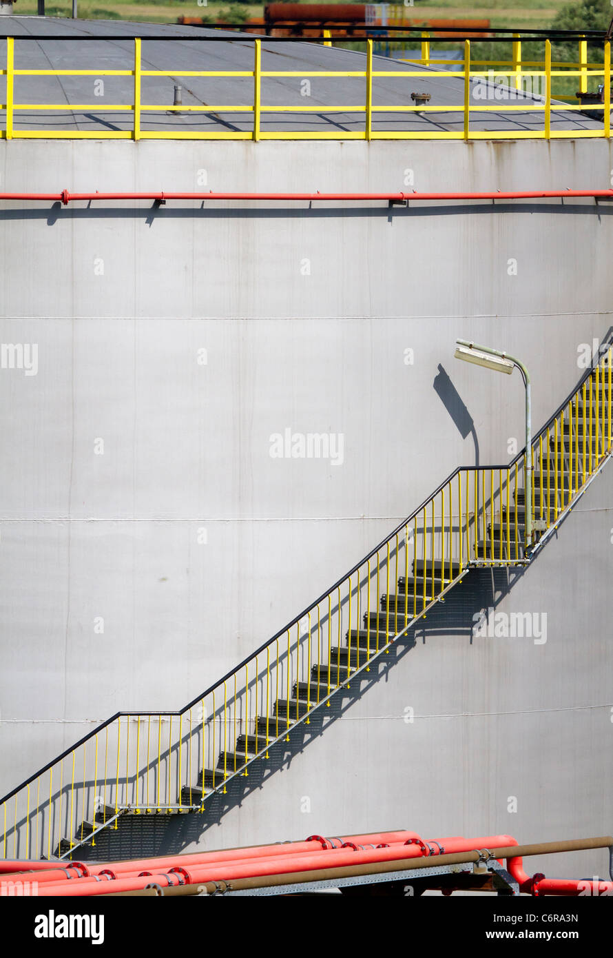 Silver-painted gasometer near the Kiel canal in Germany with red and ...