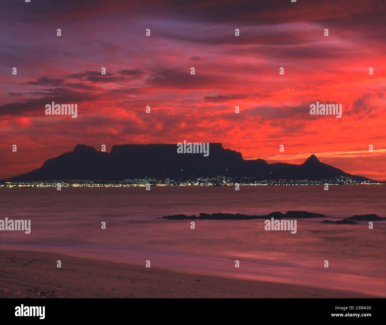 Table mountain at sunset, viewed from Blouberg beach with dramatic red ...
