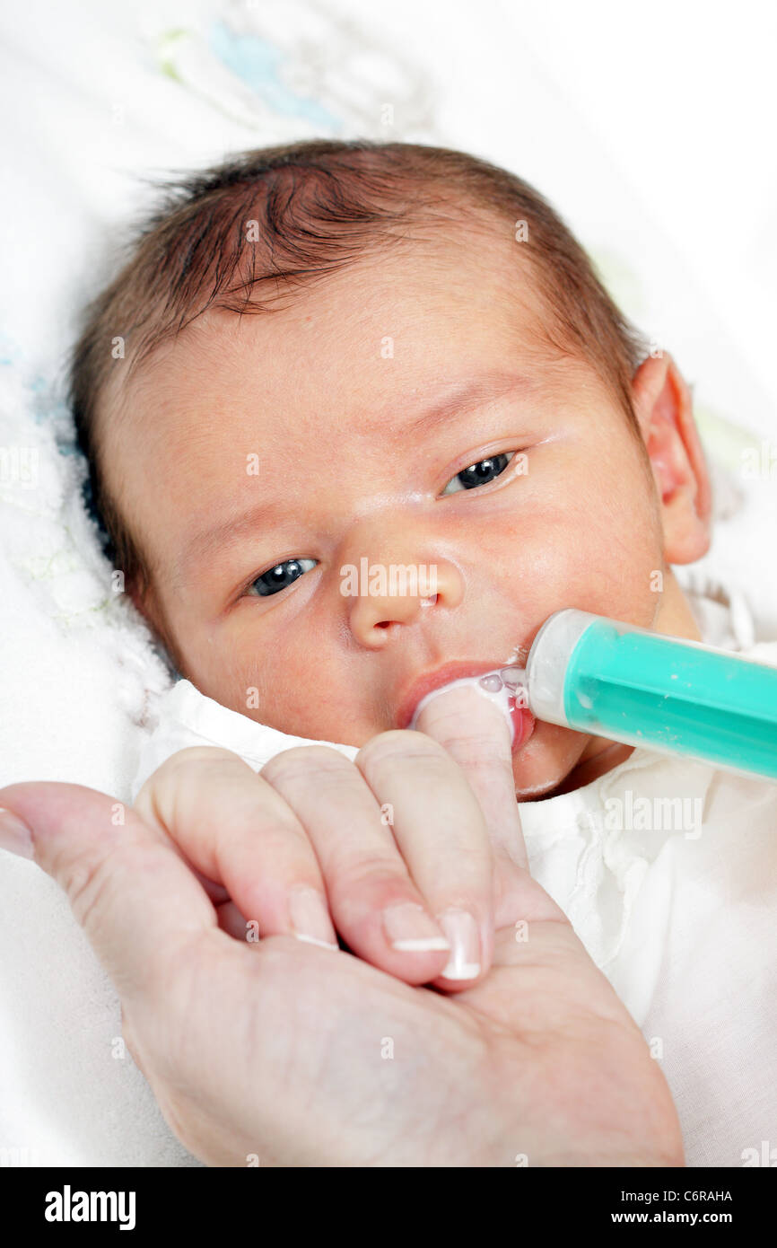 little boy drinking milk from the mother of the syringe Stock Photo - Alamy
