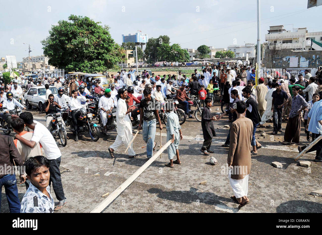 Angry protesters hold sticks during protest demonstration of residents ...