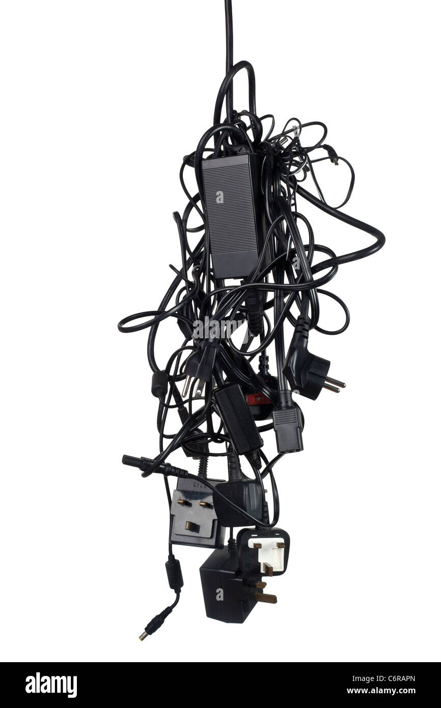 Bunch of messy tangled power cables and adapters isolated on white ...