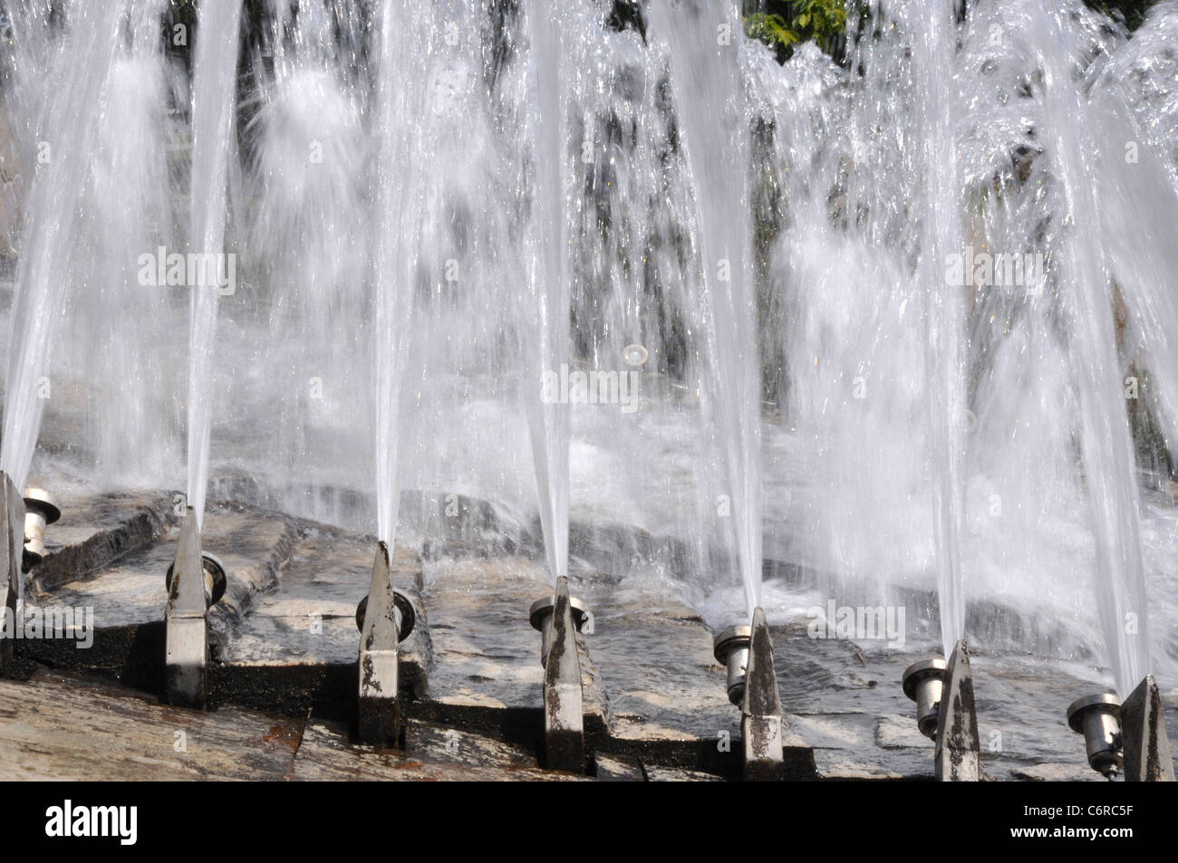 Seven fountains in a row spraying water Stock Photo - Alamy