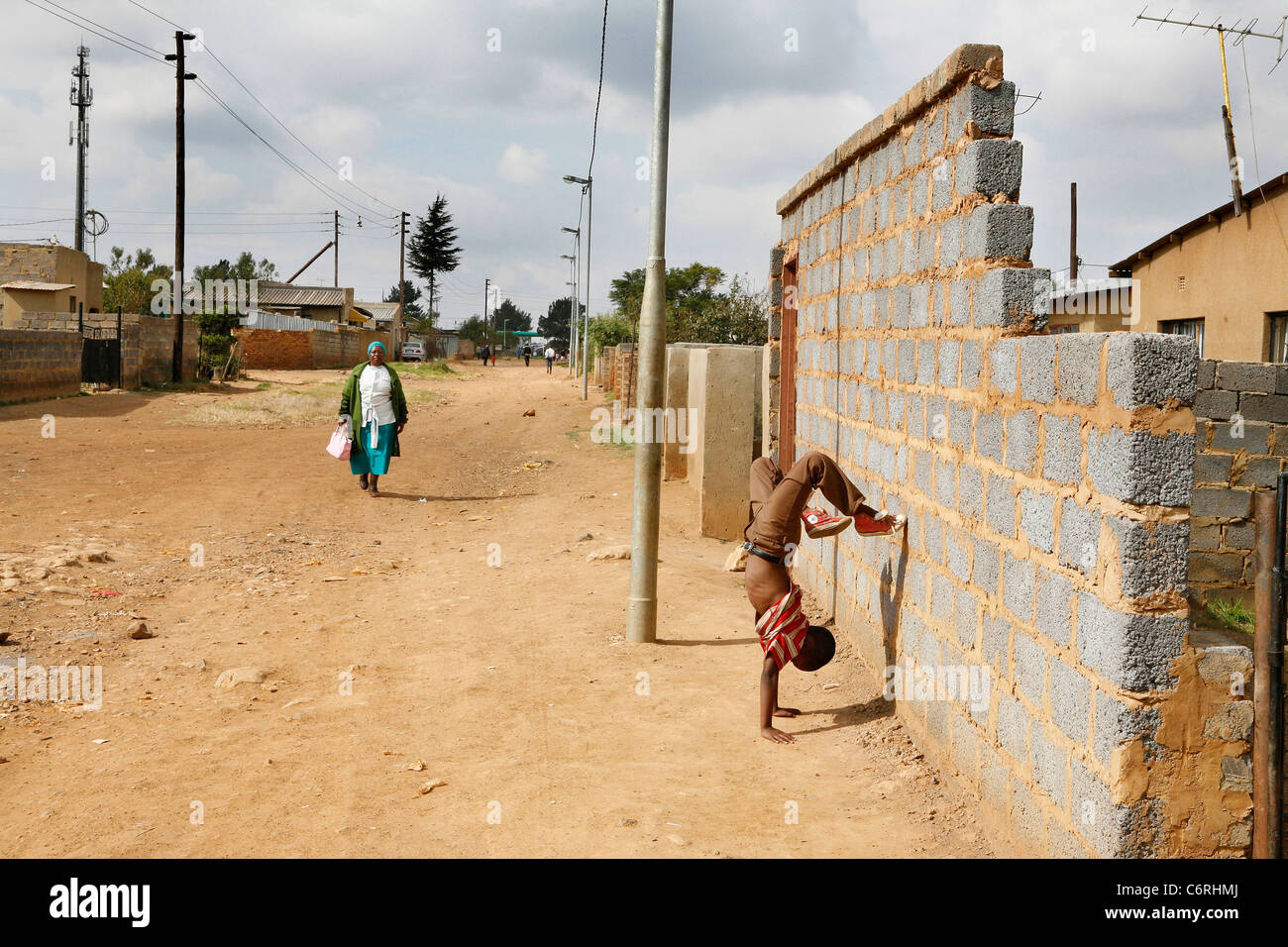 An aspiring pantsula dancer practises his moves on a street in Orange ...