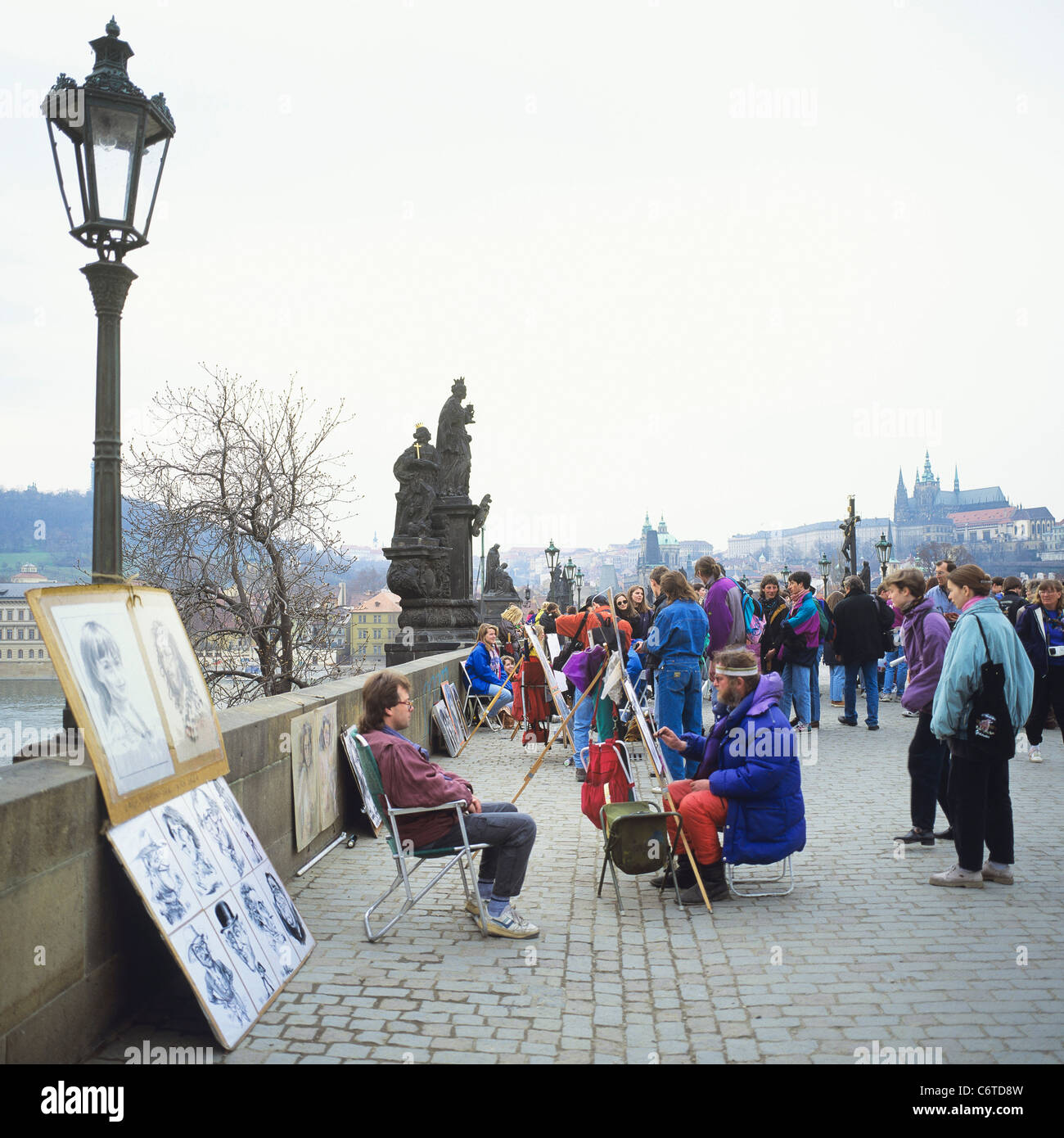 Street artists sketching tourist portraits, Charles bridge, Prague ...